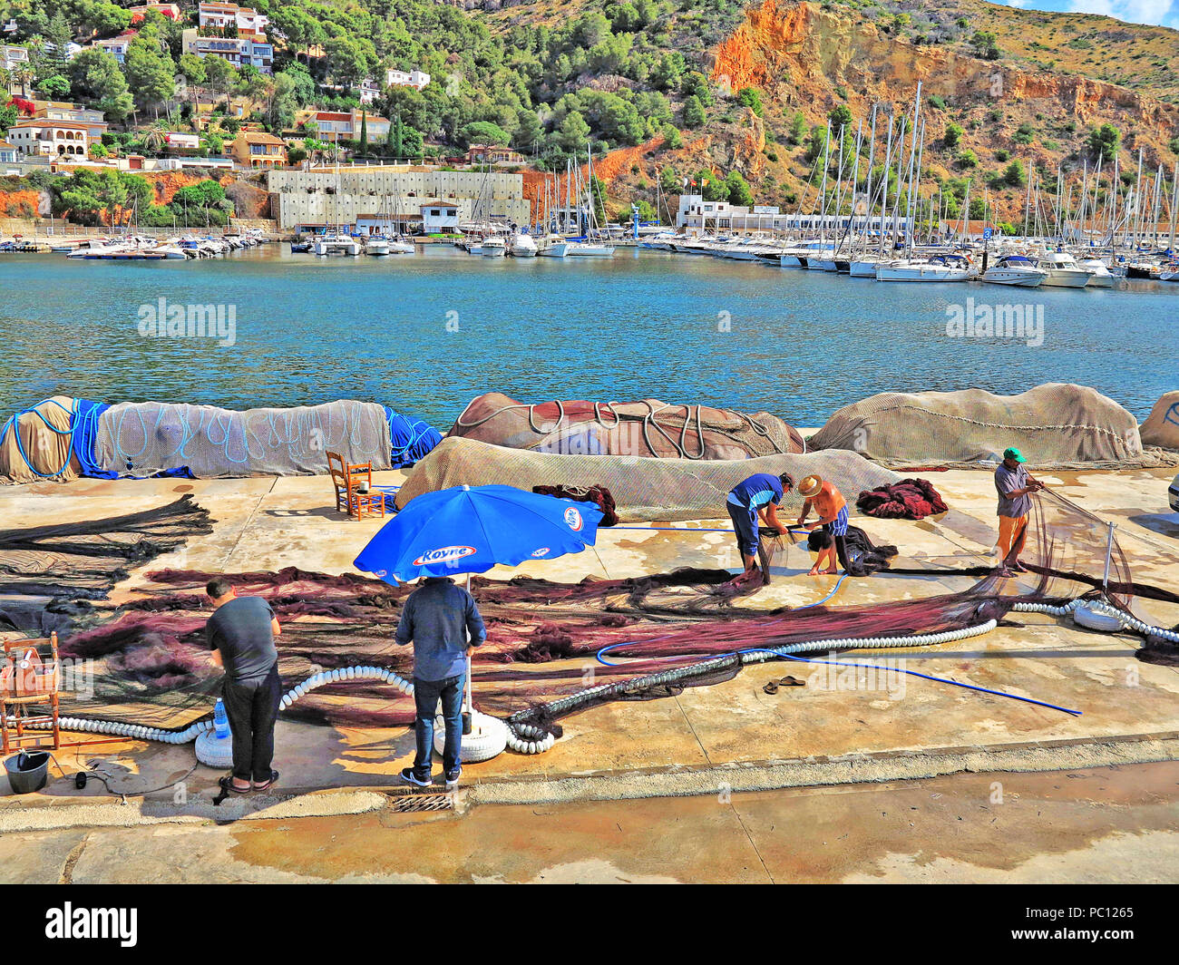 Fishing port men mending nets hi-res stock photography and images - Alamy