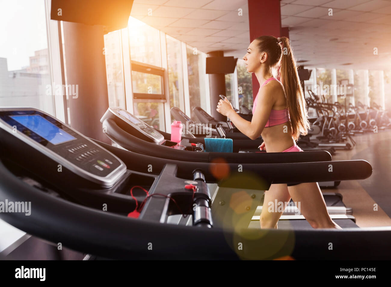 pretty girl running at the treadmill Stock Photo - Alamy