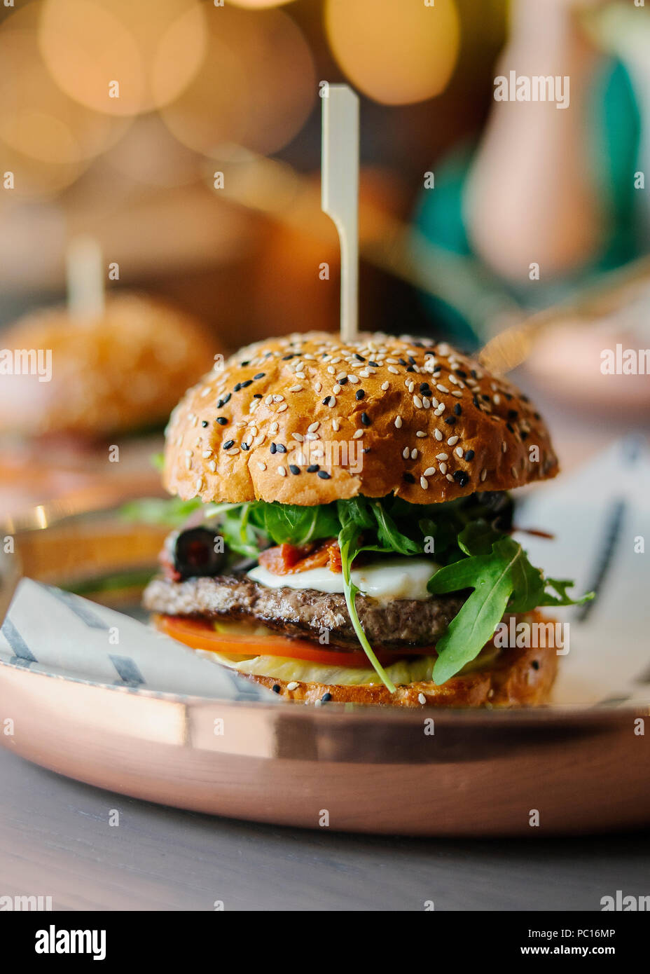 Close up of fresh burger with other burger on background in cafe Stock ...