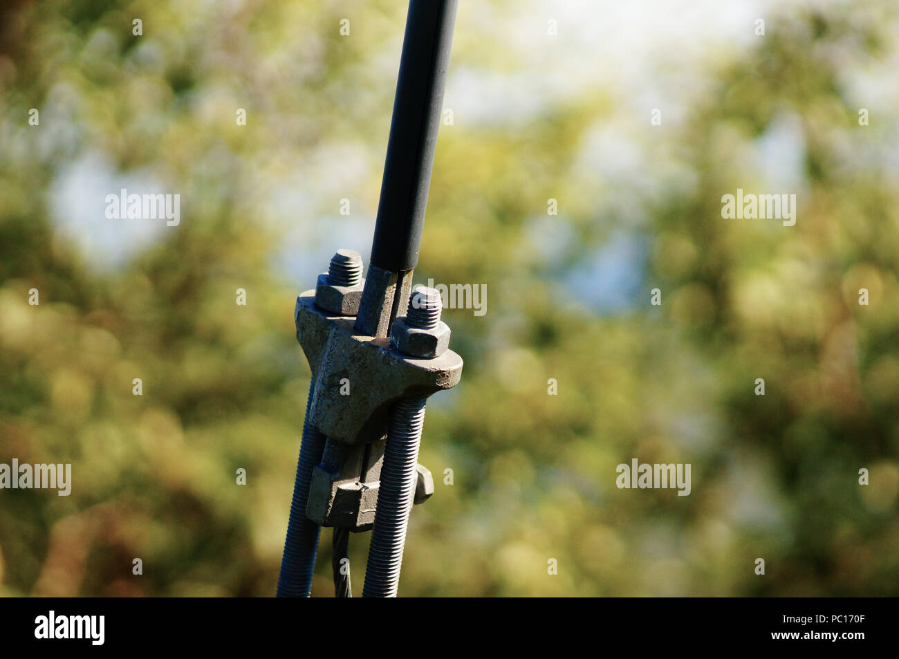 Wire and lock, supporting light pole Stock Photo - Alamy
