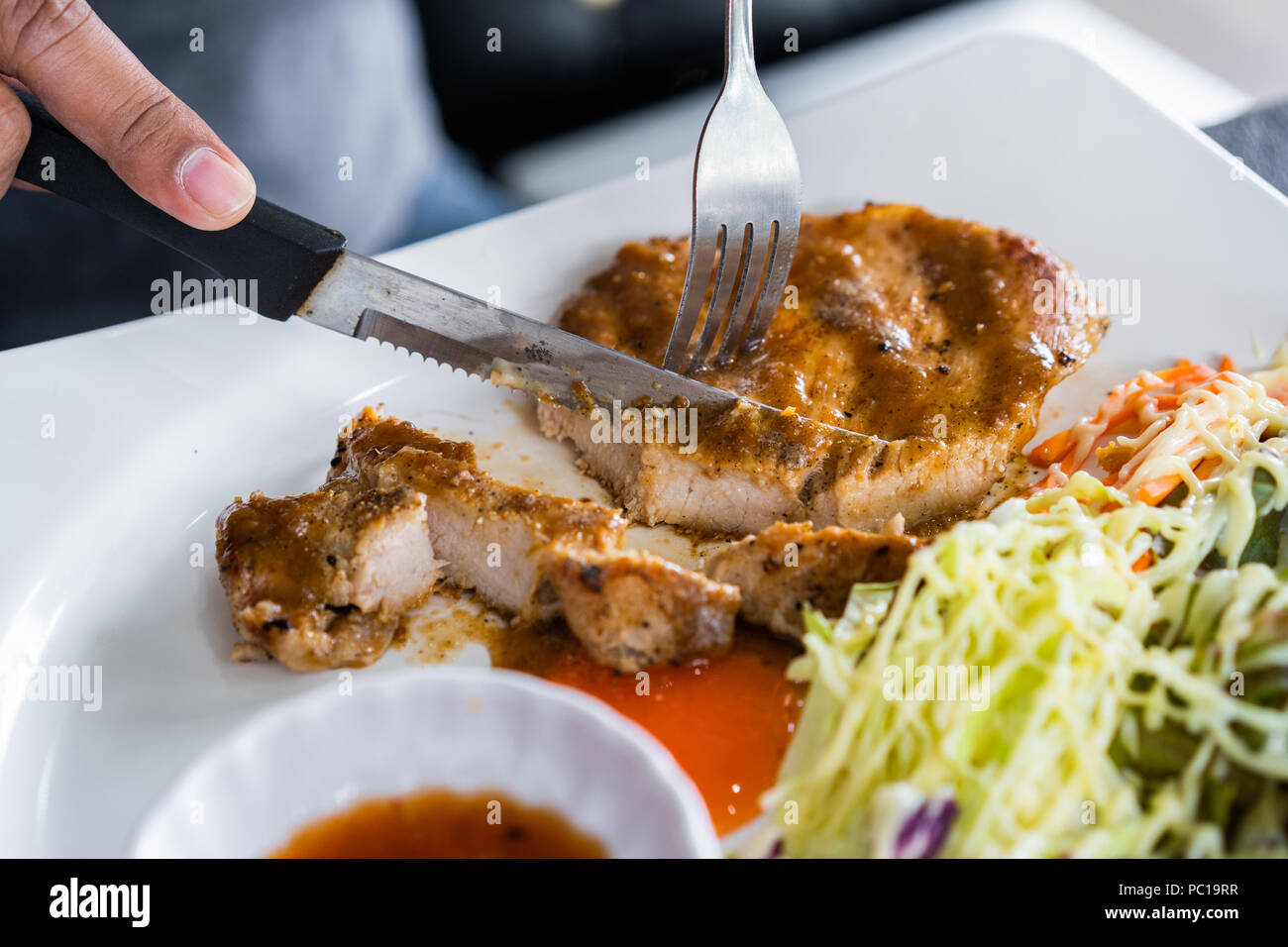 Closeup hand cutting steak knife hi-res stock photography and images ...