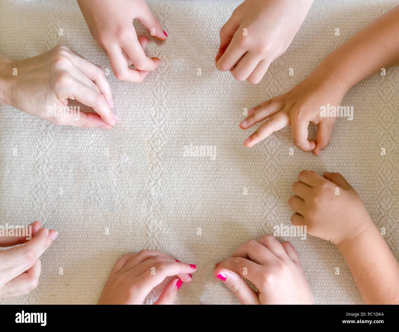 Children's and Teacher's hands together on the table Stock Photo - Alamy