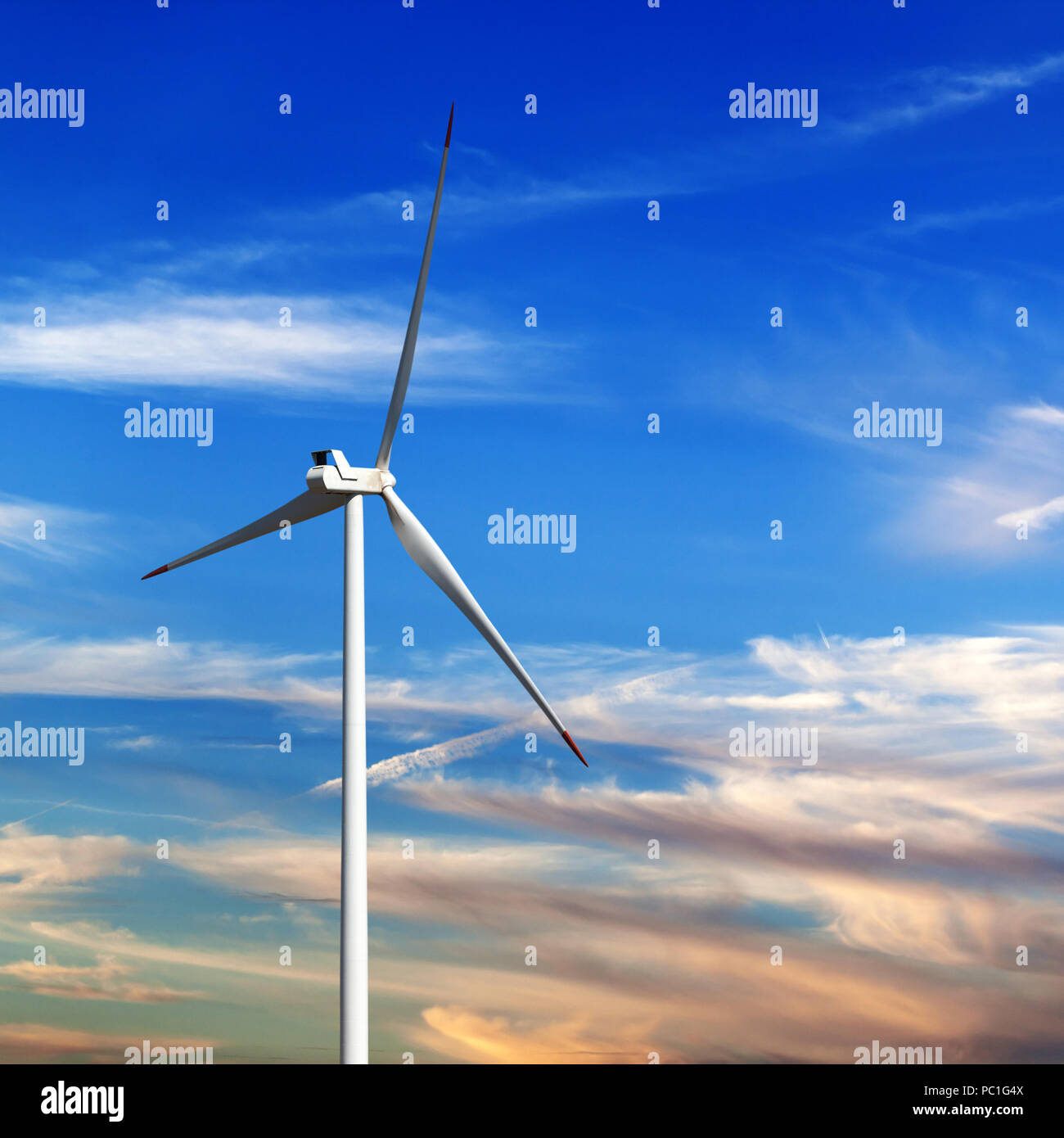 Sunlight wind turbine and multicolor sunrise sky with clouds at windy ...