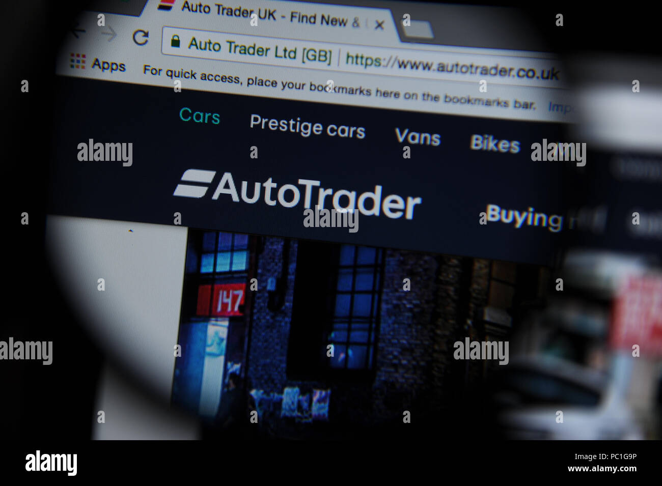 The Autotrader website seen through a magnifying glass Stock Photo - Alamy
