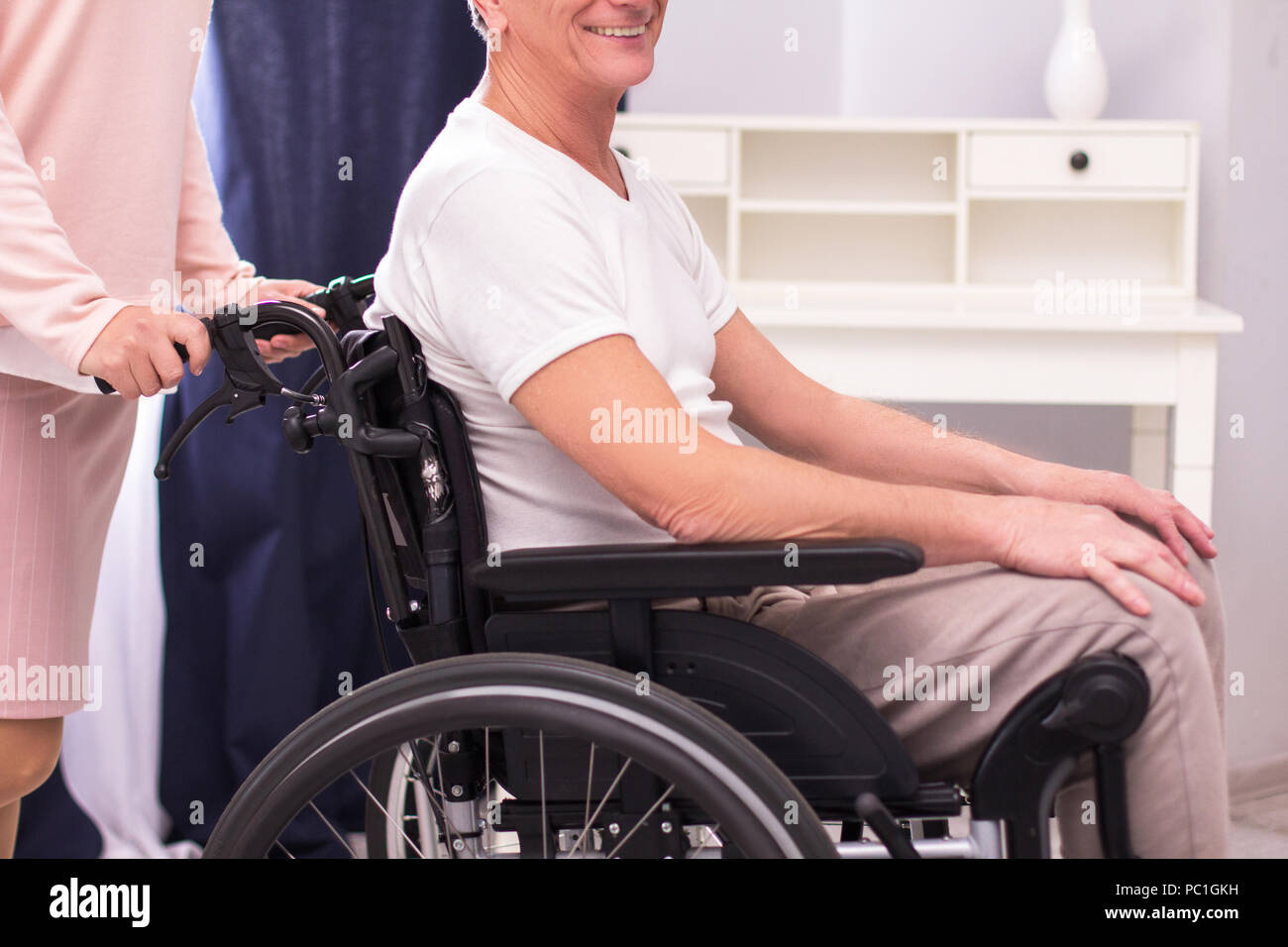 Man pushing old woman in hi-res stock photography and images - Alamy