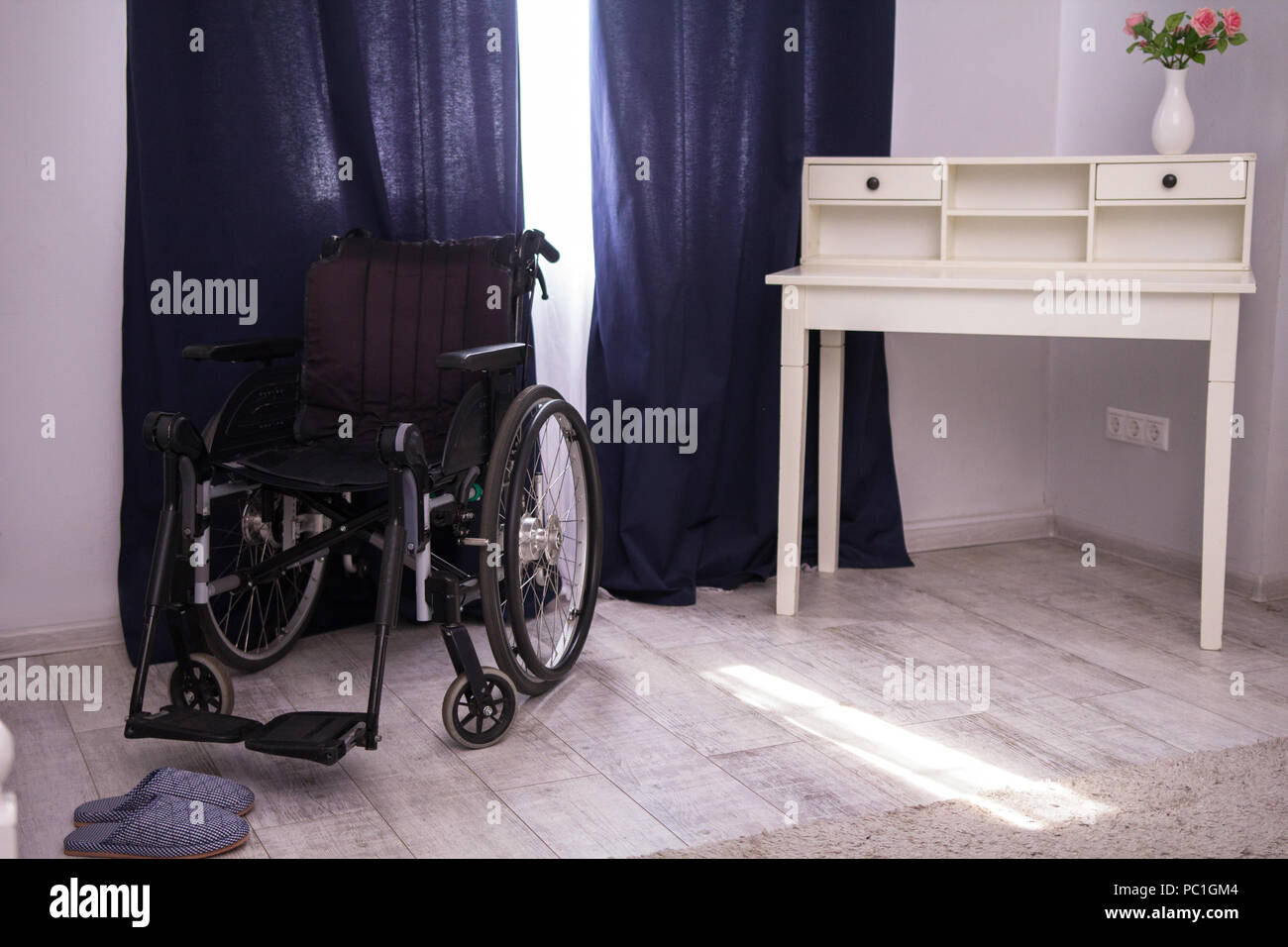Empty wheelchair in room Stock Photo - Alamy