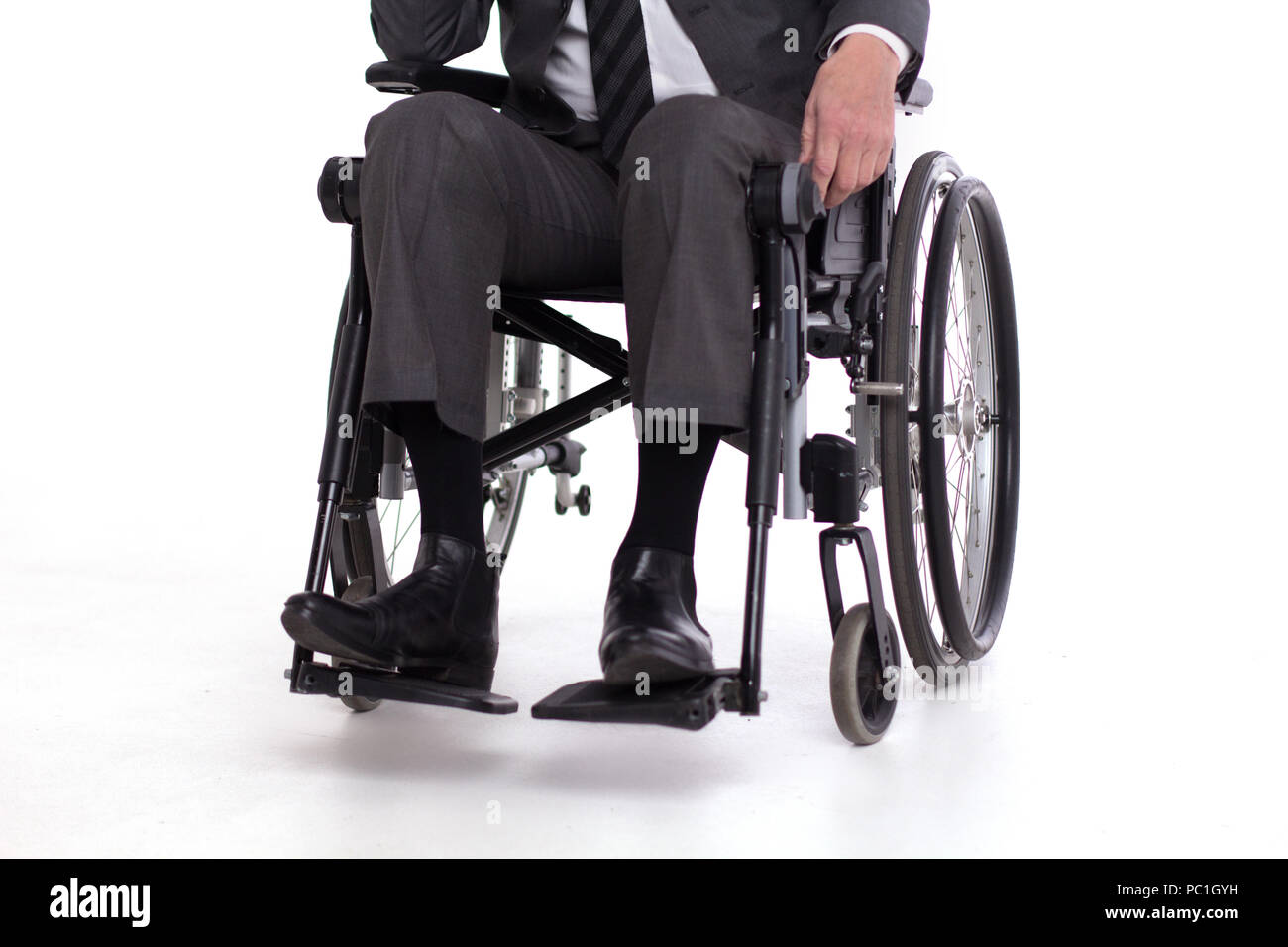 Disabled man in wheelchair in suit Stock Photo - Alamy