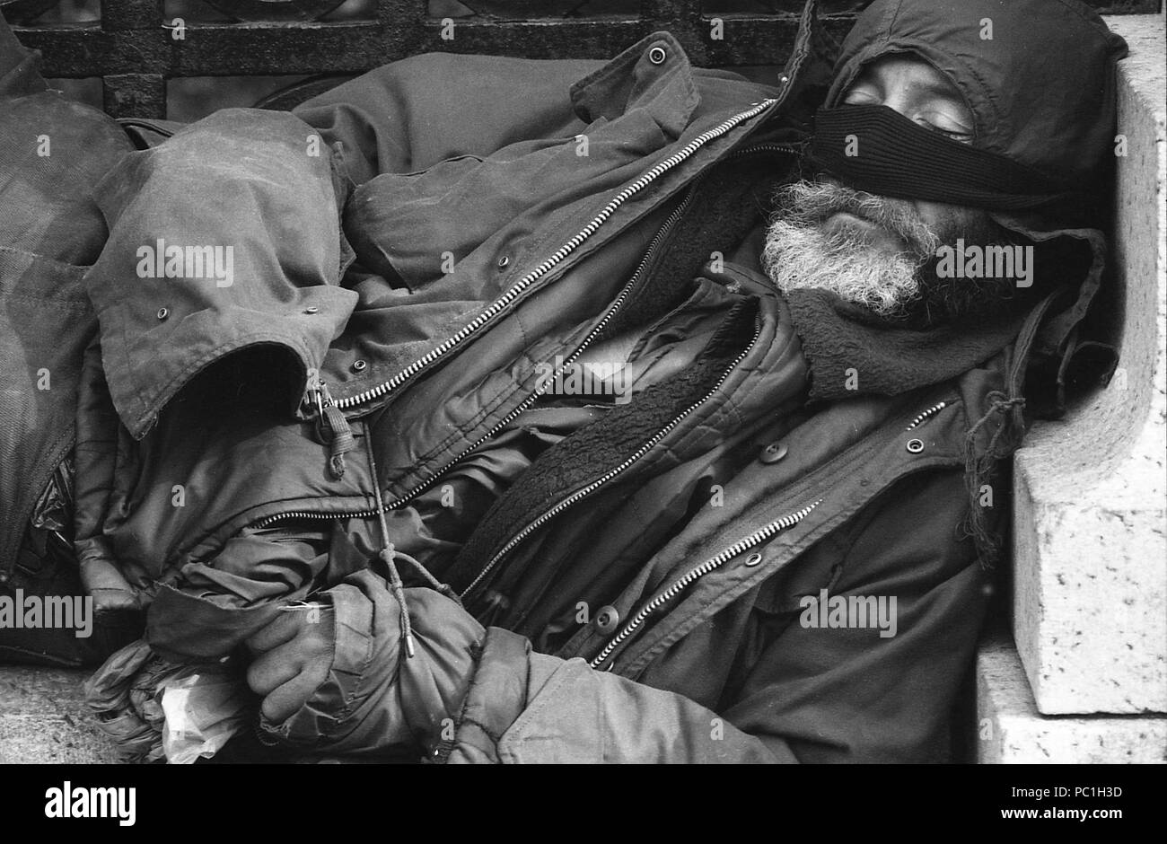 Homeless man sleeping on the street Stock Photo - Alamy