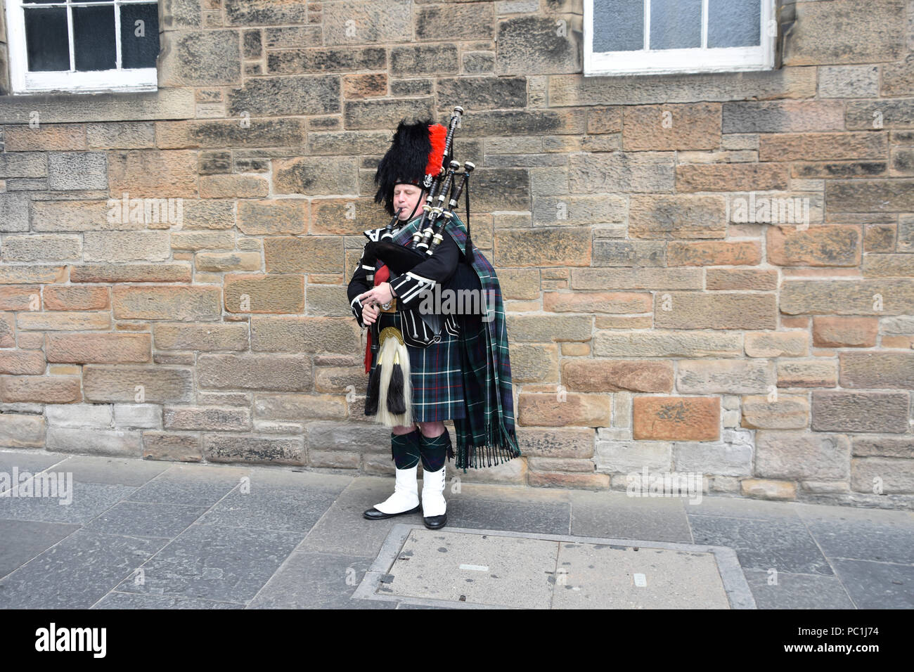 Bagpiper along Royal Mile, Edinburgh, Scotland. June, 2018 Stock Photo ...