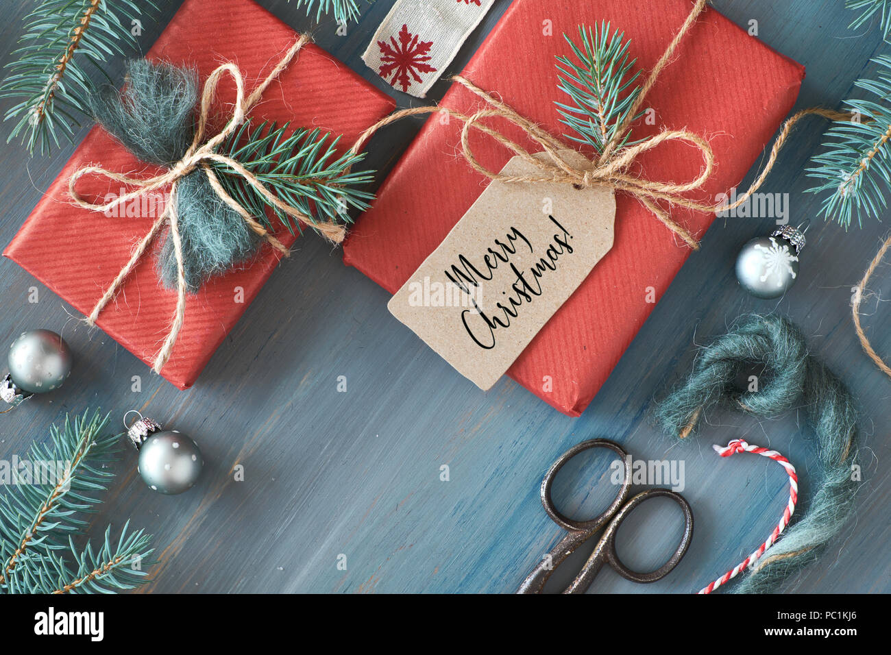 Rustic wooden background with fir branches and Christmas presents gift ...