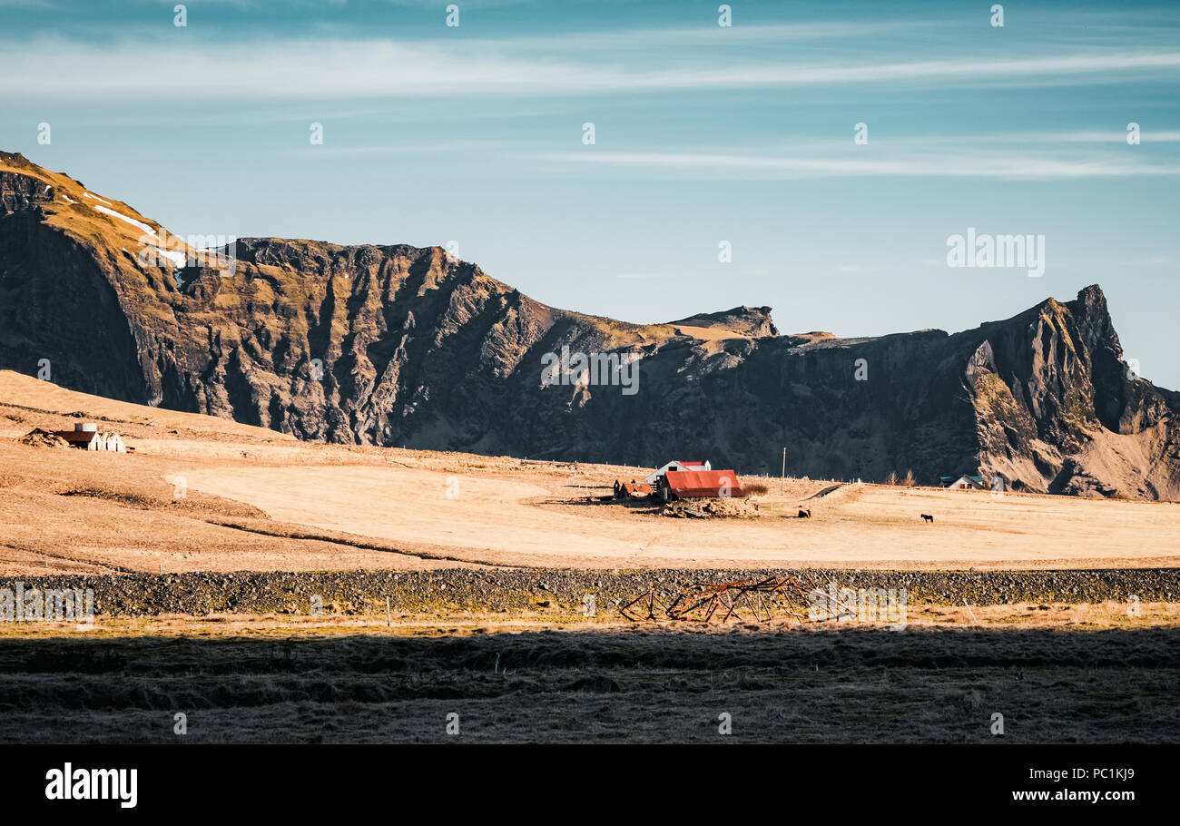 Typical Icelandic landscape with white houses red roof against ...