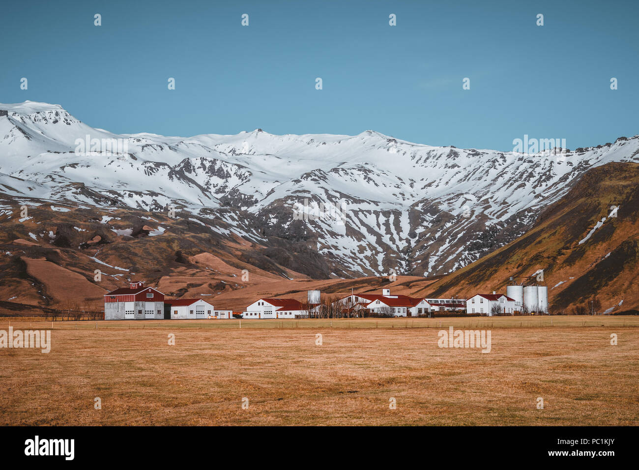 Typical Icelandic landscape with white houses red roof against ...