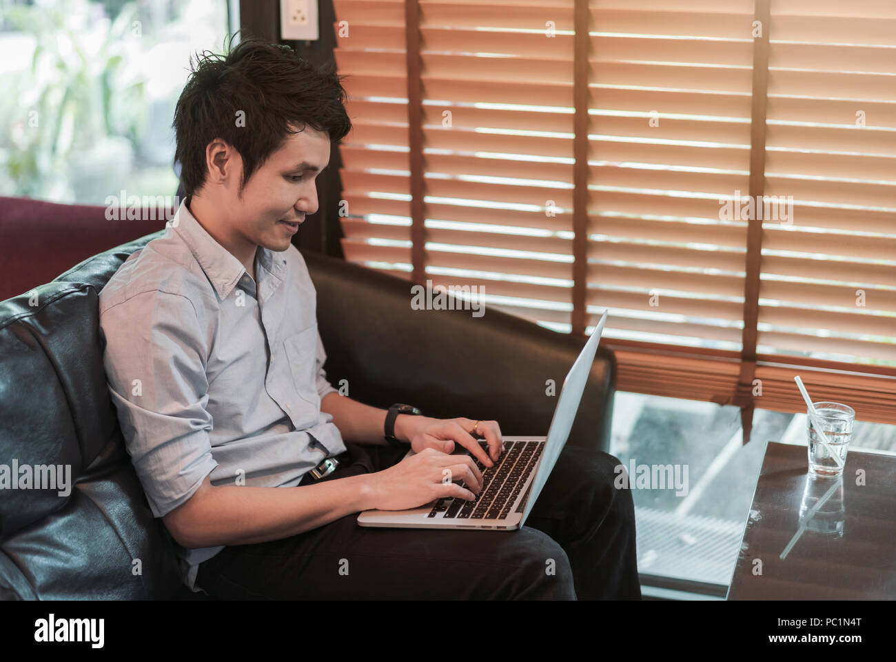 man using laptop computer in a cafe Stock Photo - Alamy