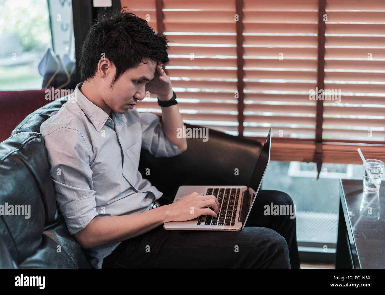 man under a lot of stress using laptop computer in a cafe Stock Photo ...