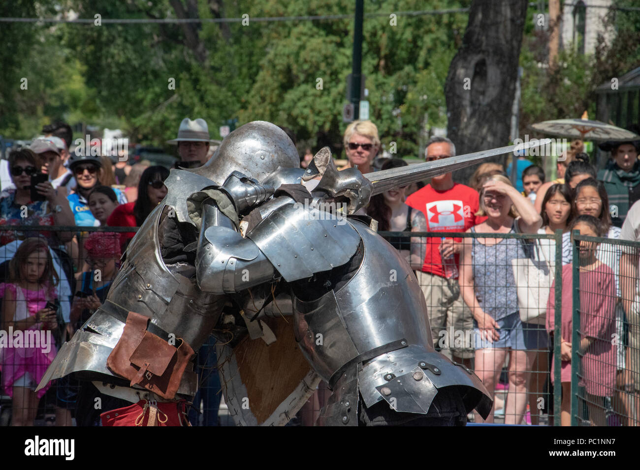 A crowd gathers to watch a Sword Fighting Demonstration at the Fantasy ...