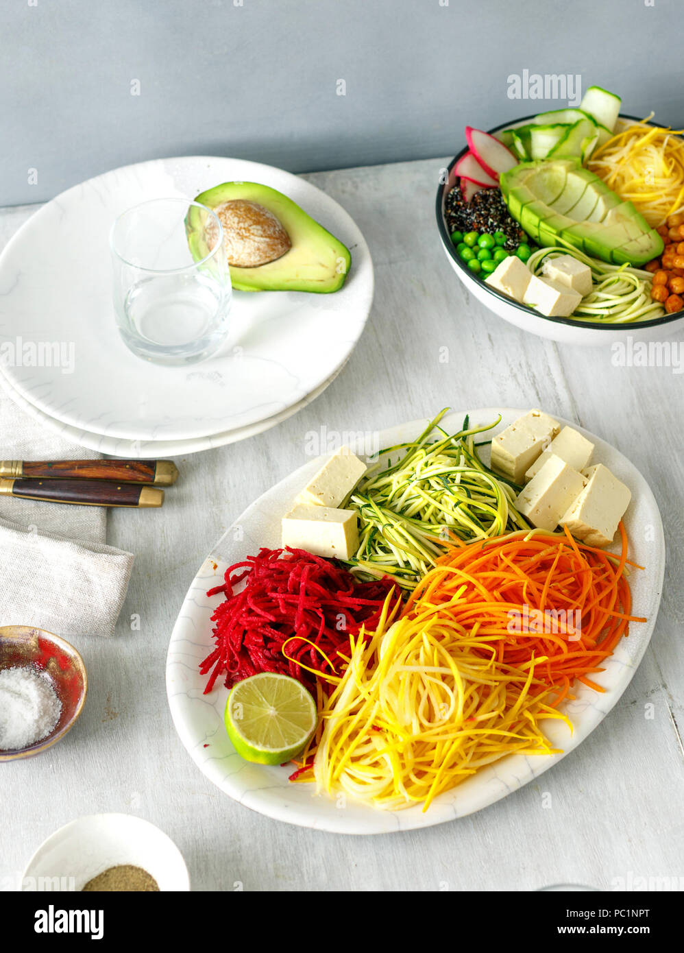 Spiralized vegetables with bowl of buddha on white wooden table ...