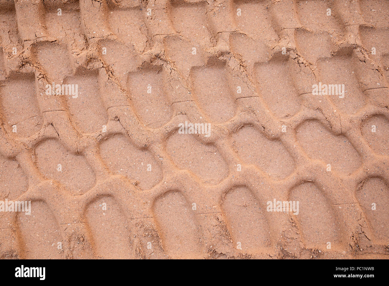 Footprints in the land of the tire tread Stock Photo - Alamy