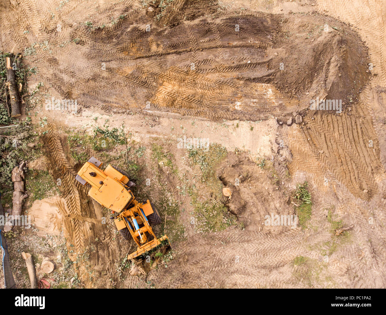 wheel loader machine working at construction site, aerial top view ...