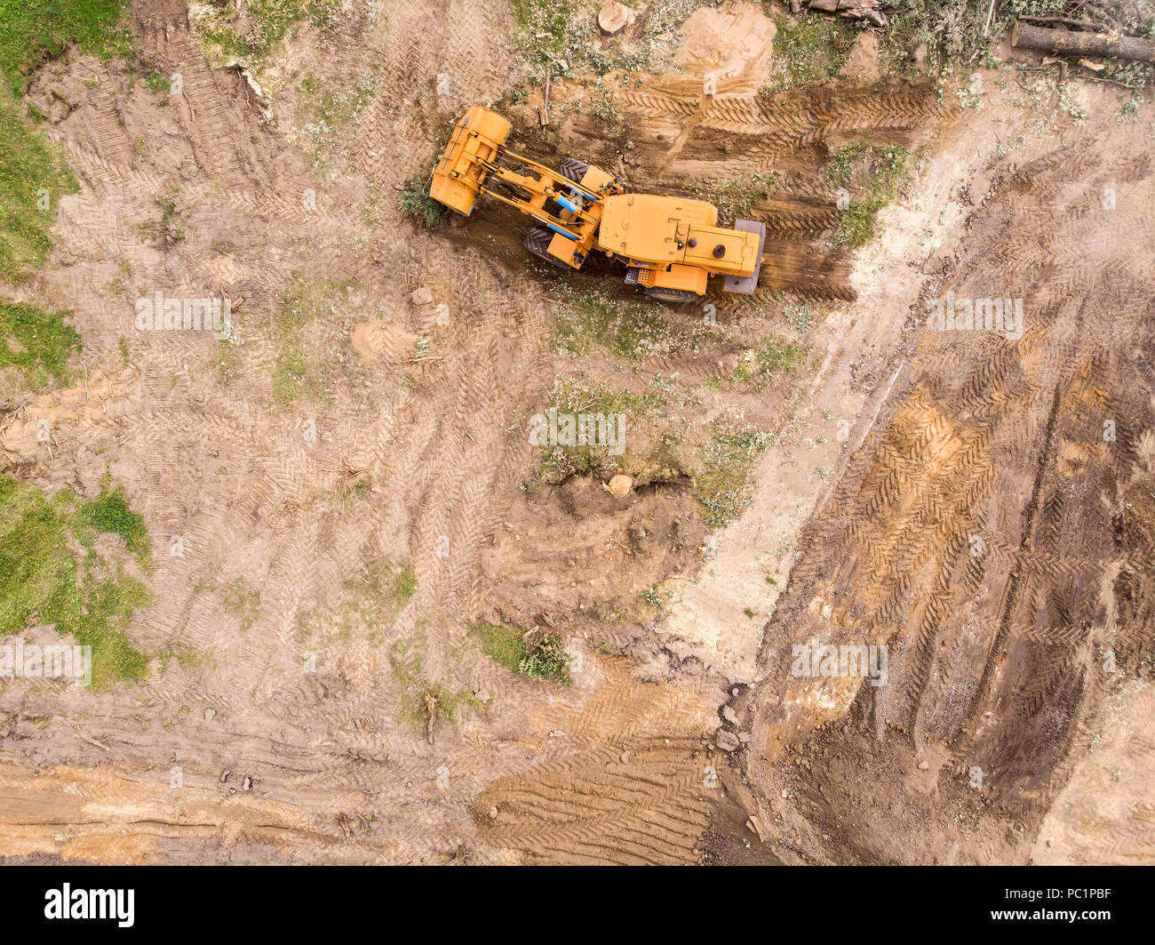 yellow wheel loader machine doing leveling ground. building site ...