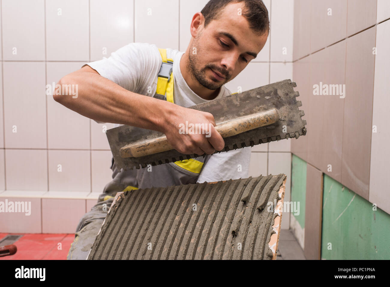 Install ceramic tiles hi-res stock photography and images - Alamy