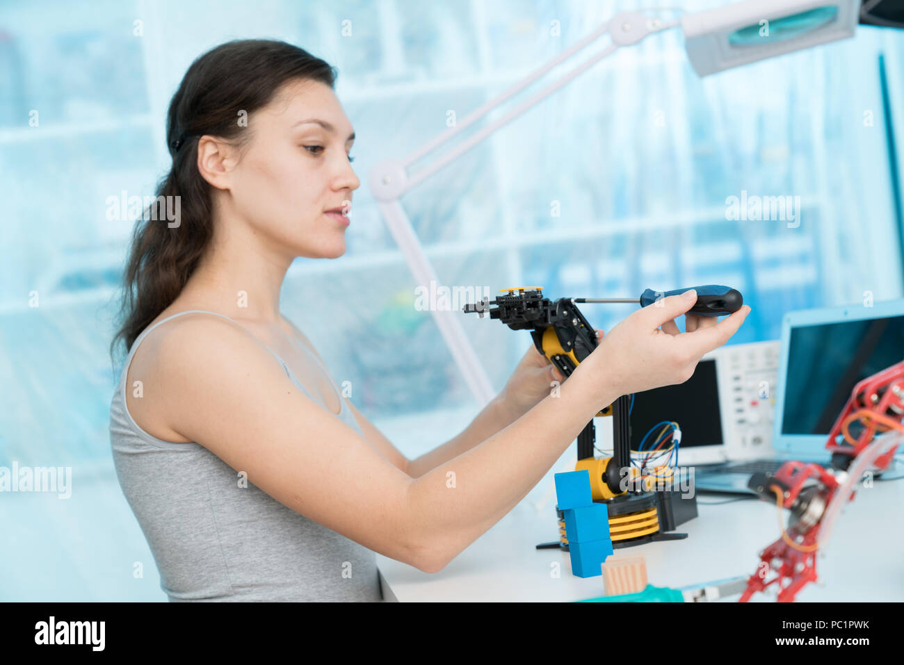 girl in a University laboratory is experimenting with a robot Stock ...