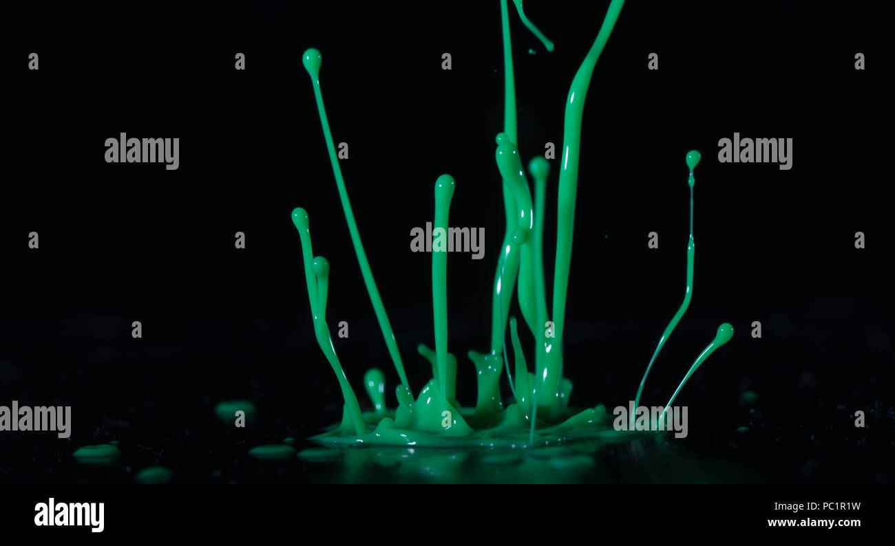 Green paint, ink splash on black background Stock Photo - Alamy