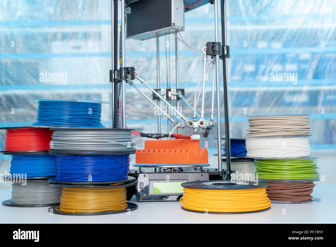 ABS and PLA filament next to 3D Printer. Plastic coils Stock Photo - Alamy