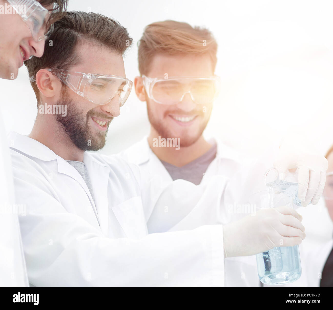 group of scientists working with chemicals Stock Photo - Alamy