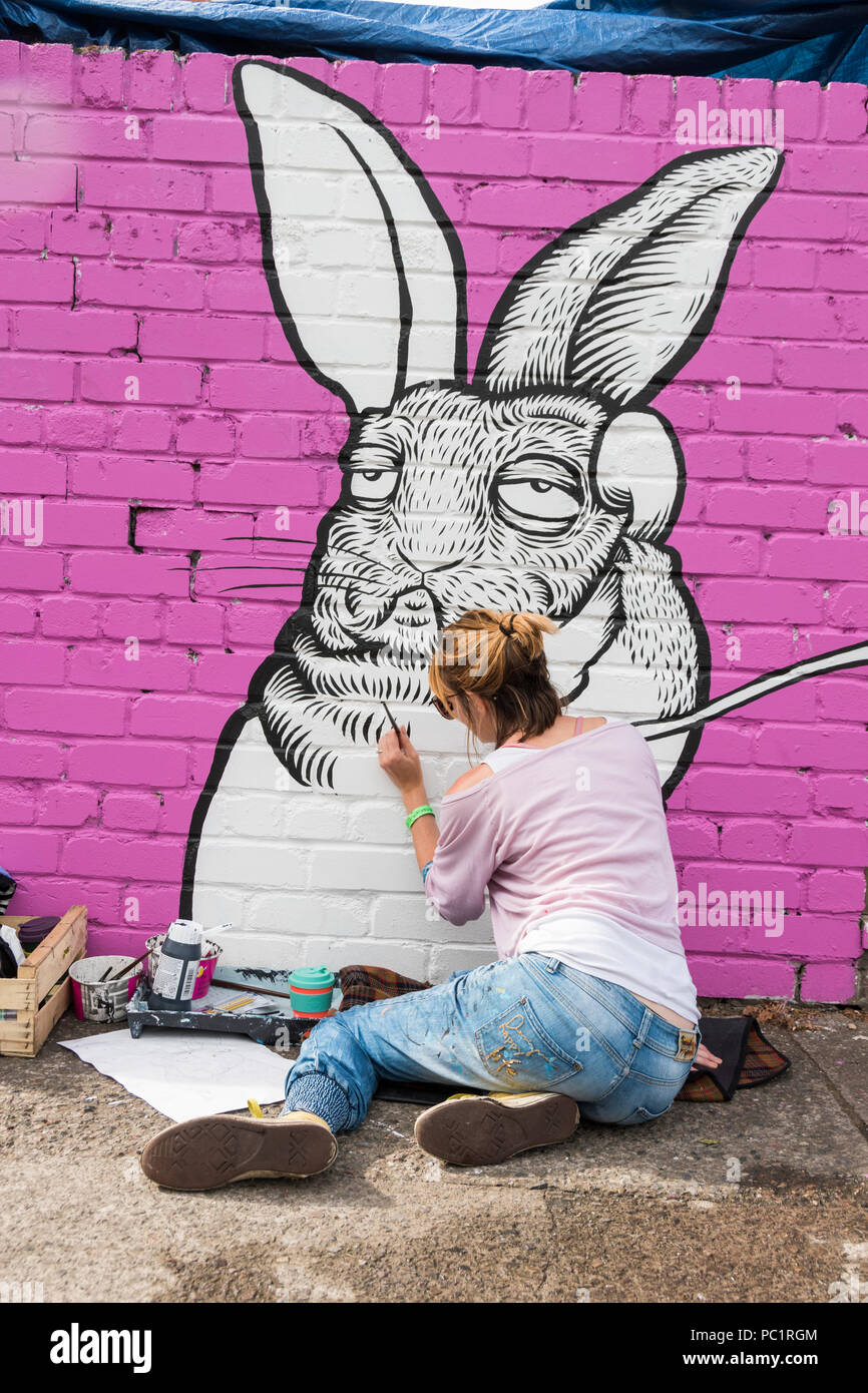 Alex Lucas of Lucas Antics working on her painted wall mural at 10th ...