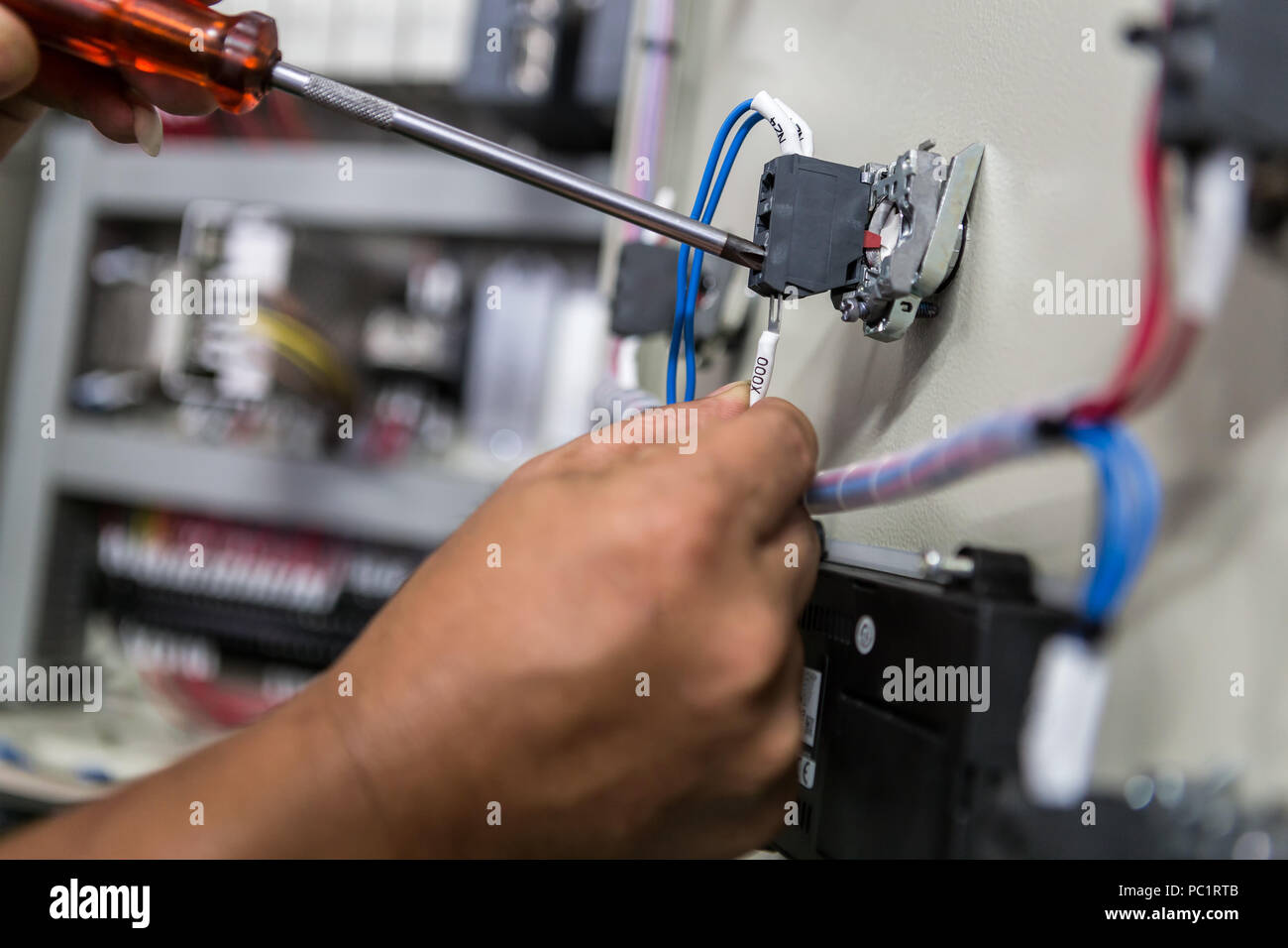 Electricians hands repair switches in electric control Stock Photo - Alamy