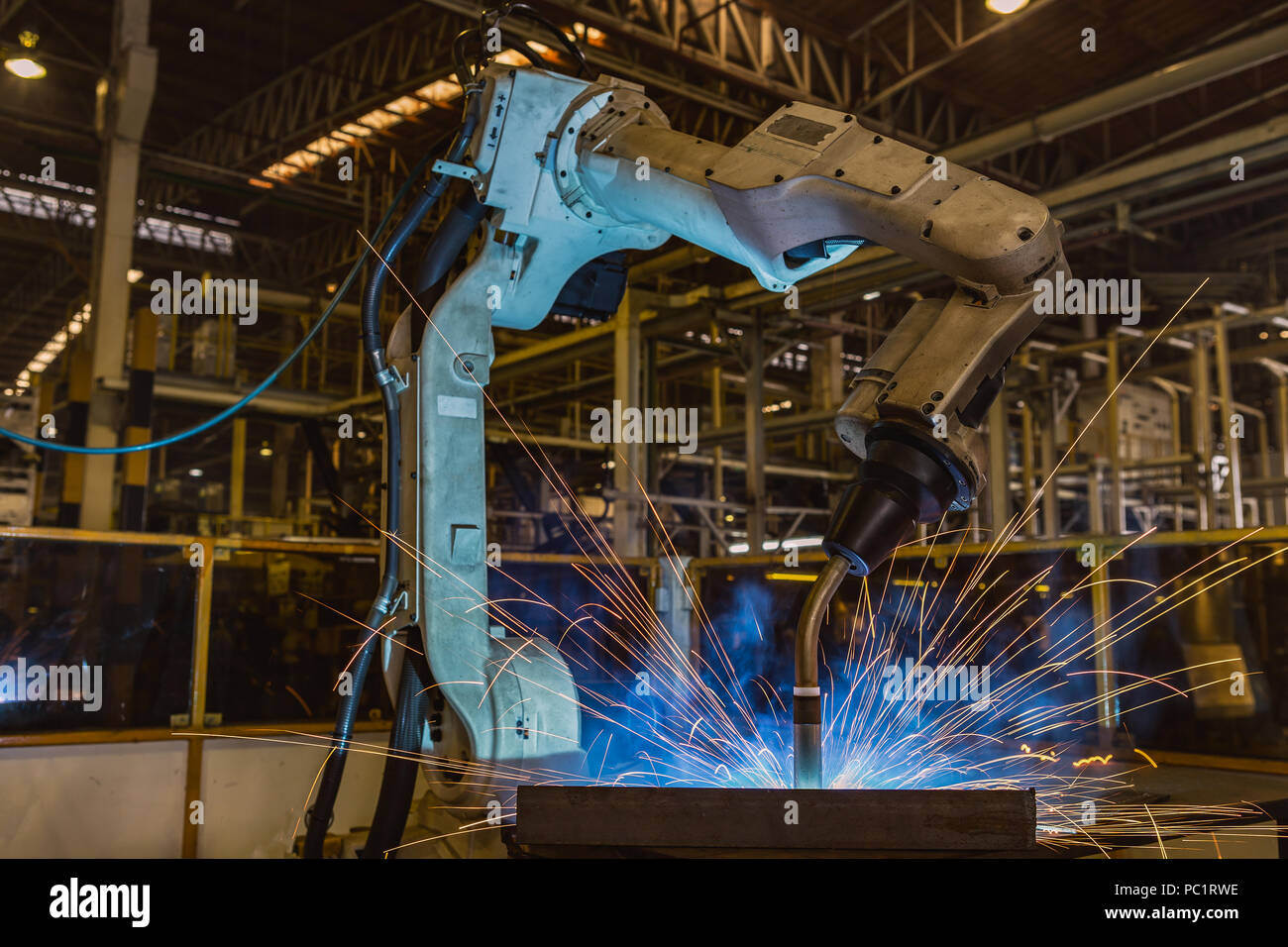 Industrial robot is movement welding metal in factory Stock Photo - Alamy