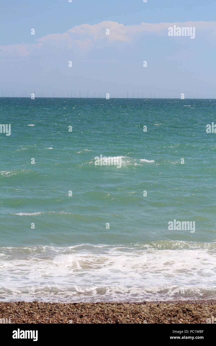 Tide coming in over a pebbled beach Stock Photo - Alamy