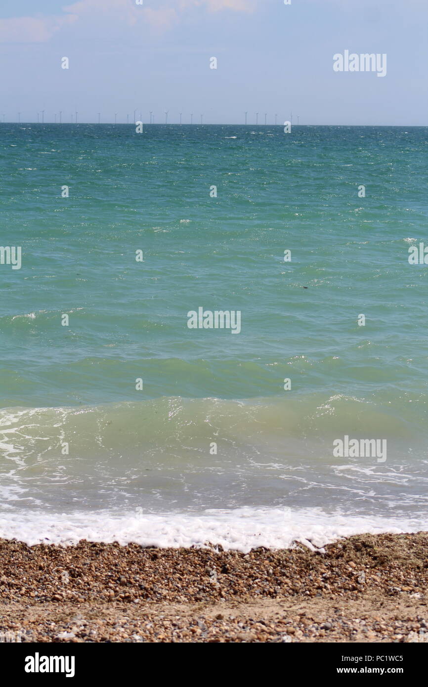 Tide coming in over pebbled beach in Goring-by-sea Stock Photo - Alamy