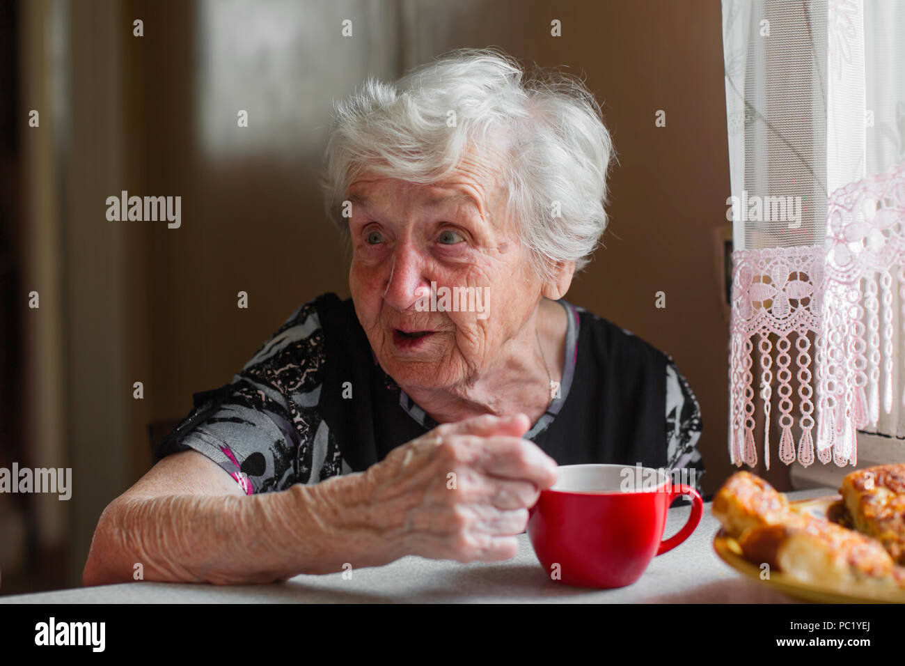 Older woman drinking tea sitting hi-res stock photography and images ...