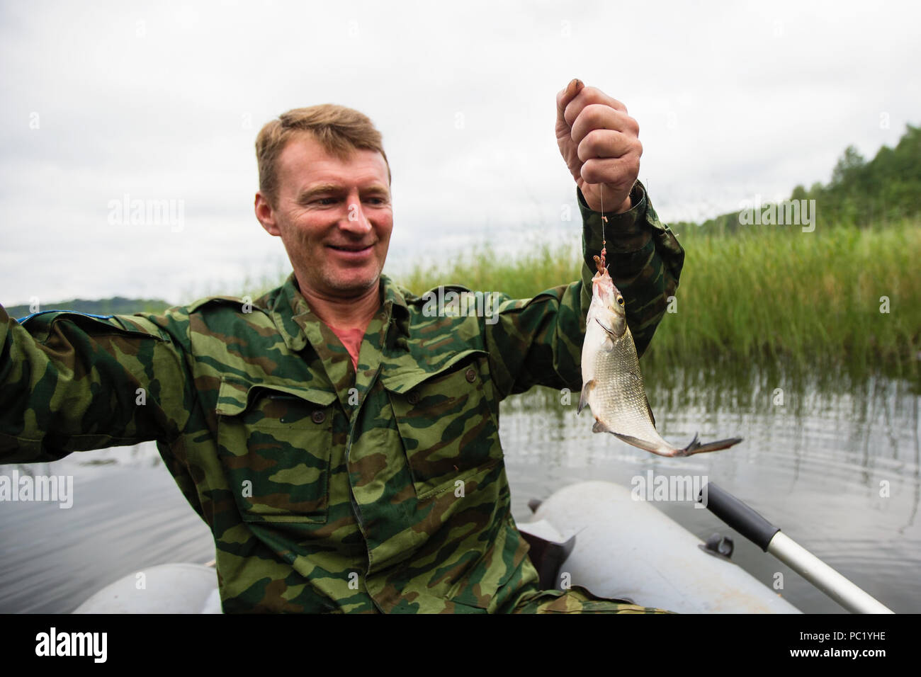Fisherman catching big fish from boat hi-res stock photography and ...