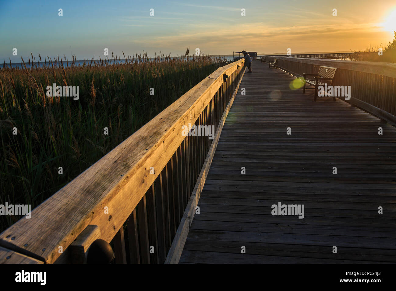 Strong sunset light from scene's edge illuminates sky, clouds ...