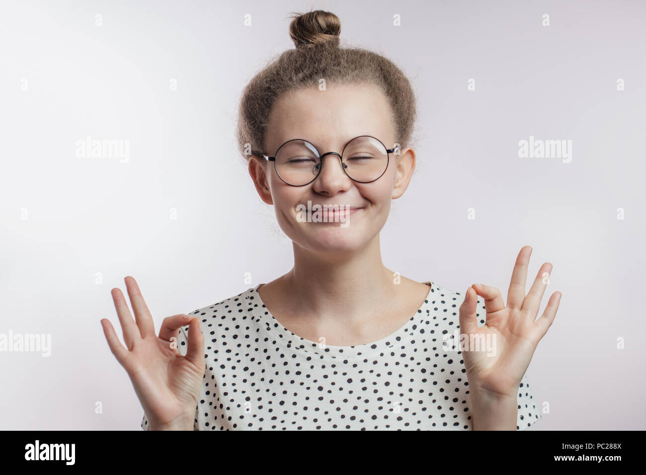 smiling pleasant girl trying to concentrating on her thoughts Stock ...