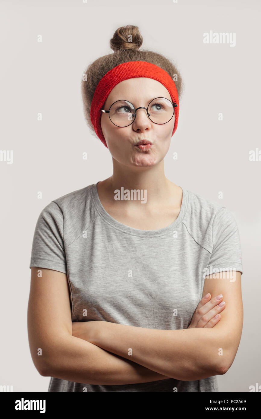 beautiful girl with puresed lips is trying to whistle. fitness girl ...