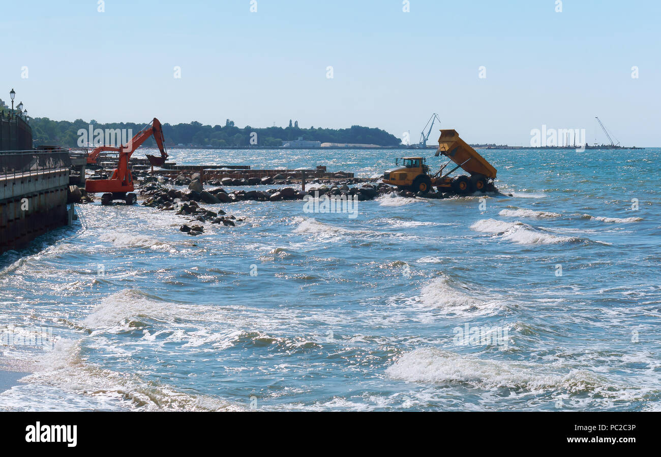 construction equipment on the shore, the construction of breakwaters ...