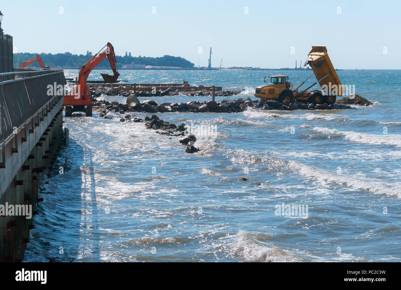 construction equipment on the shore, the construction of breakwaters ...