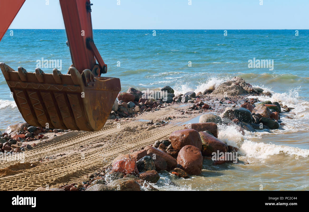 construction equipment on the shore, the construction of breakwaters ...