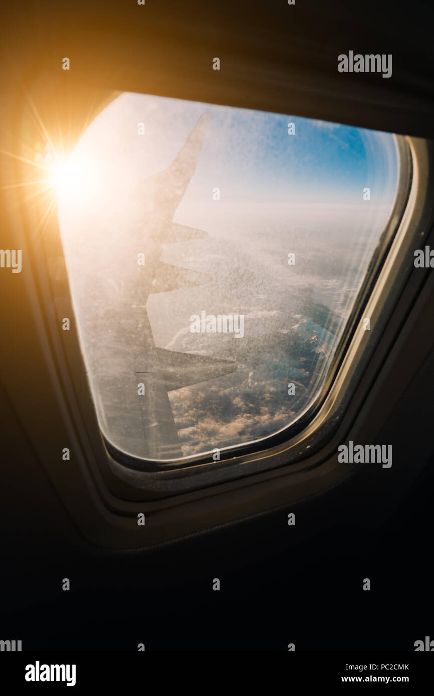 Evening airplane flight in twilight sky. Sunset view in cabin frozen ...