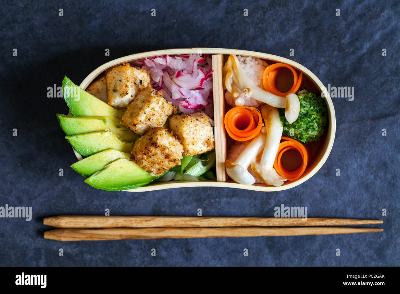 Japanese bento box lunch withg mushrooms, onigiri and tofu Stock Photo ...