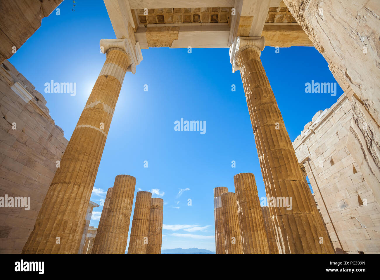 Looking up at a columns of Propylaea gateway in Acropolis of Athens ...
