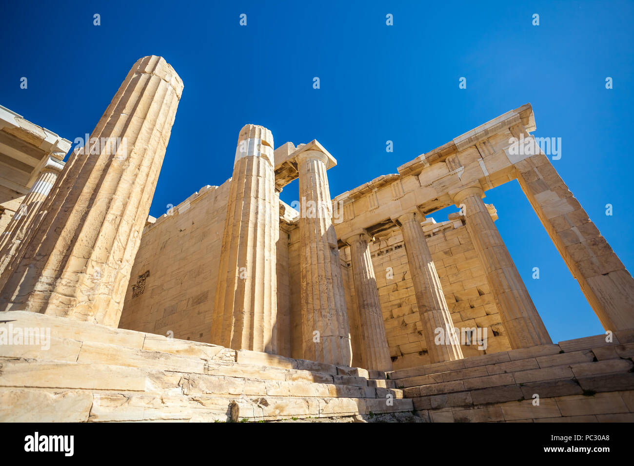 Looking up at a columns of Propylaea gateway in Acropolis of Athens ...