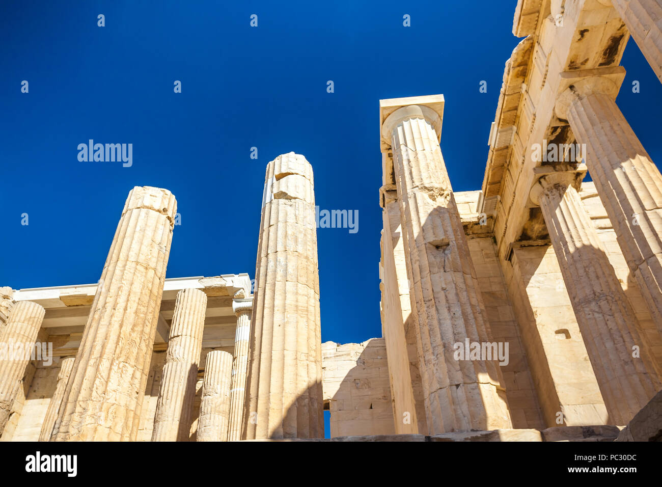 Looking up at a columns of Propylaea gateway in Acropolis of Athens ...