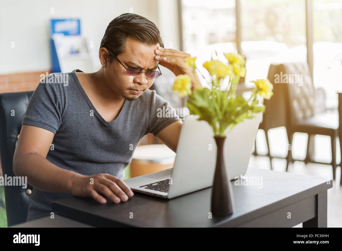man under a lot of stress using laptop computer in cafe Stock Photo - Alamy