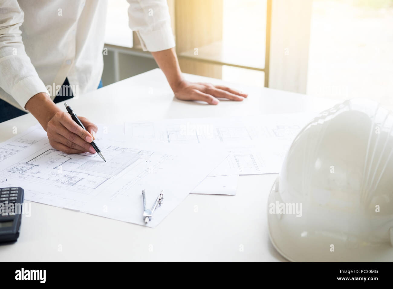 Close-up Of Person's engineer Hand Drawing Plan On Blue Print with ...