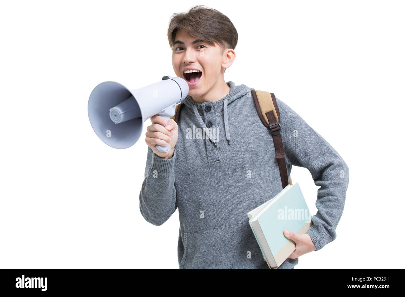 Cheerful male college student shouting through megaphone Stock Photo ...