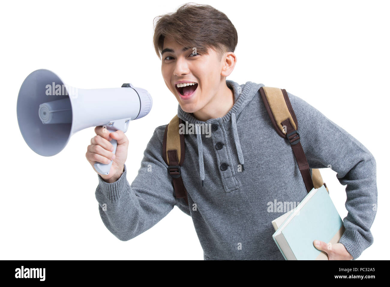 Cheerful male college student shouting through megaphone Stock Photo ...
